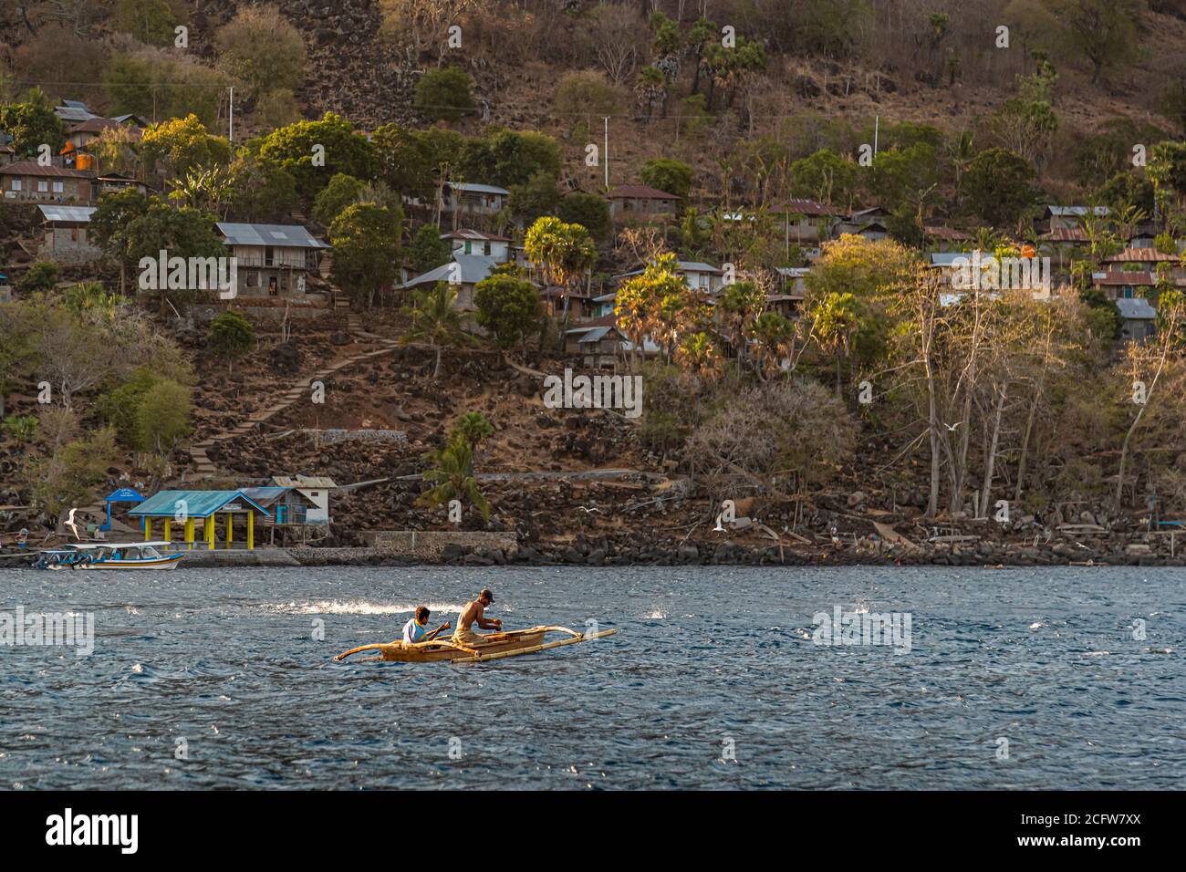 Fishermen in Jukung (indonesian wooden outrigger canoe), Sunda Islands ...