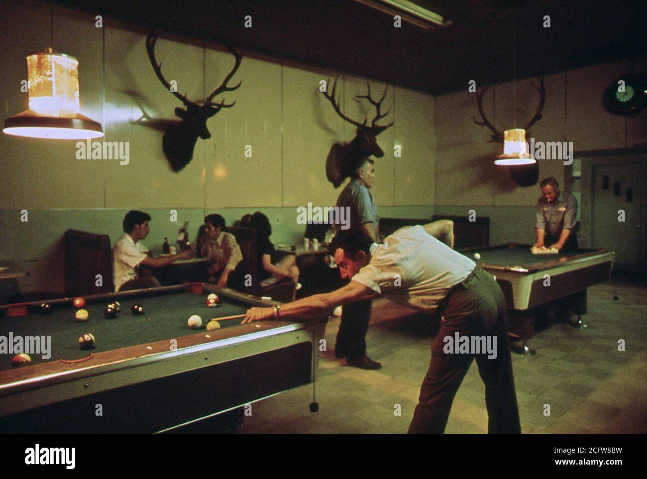 early 1970s pool hall men playing pool and drinking beer Stock Photo ...
