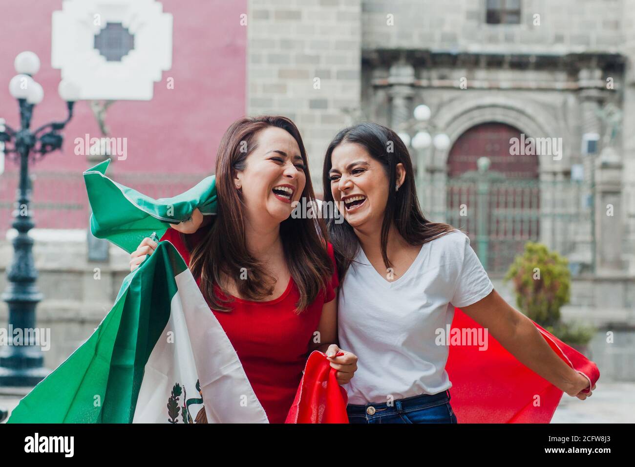 mexican girls friends at independence day in Mexico holding a flag of ...