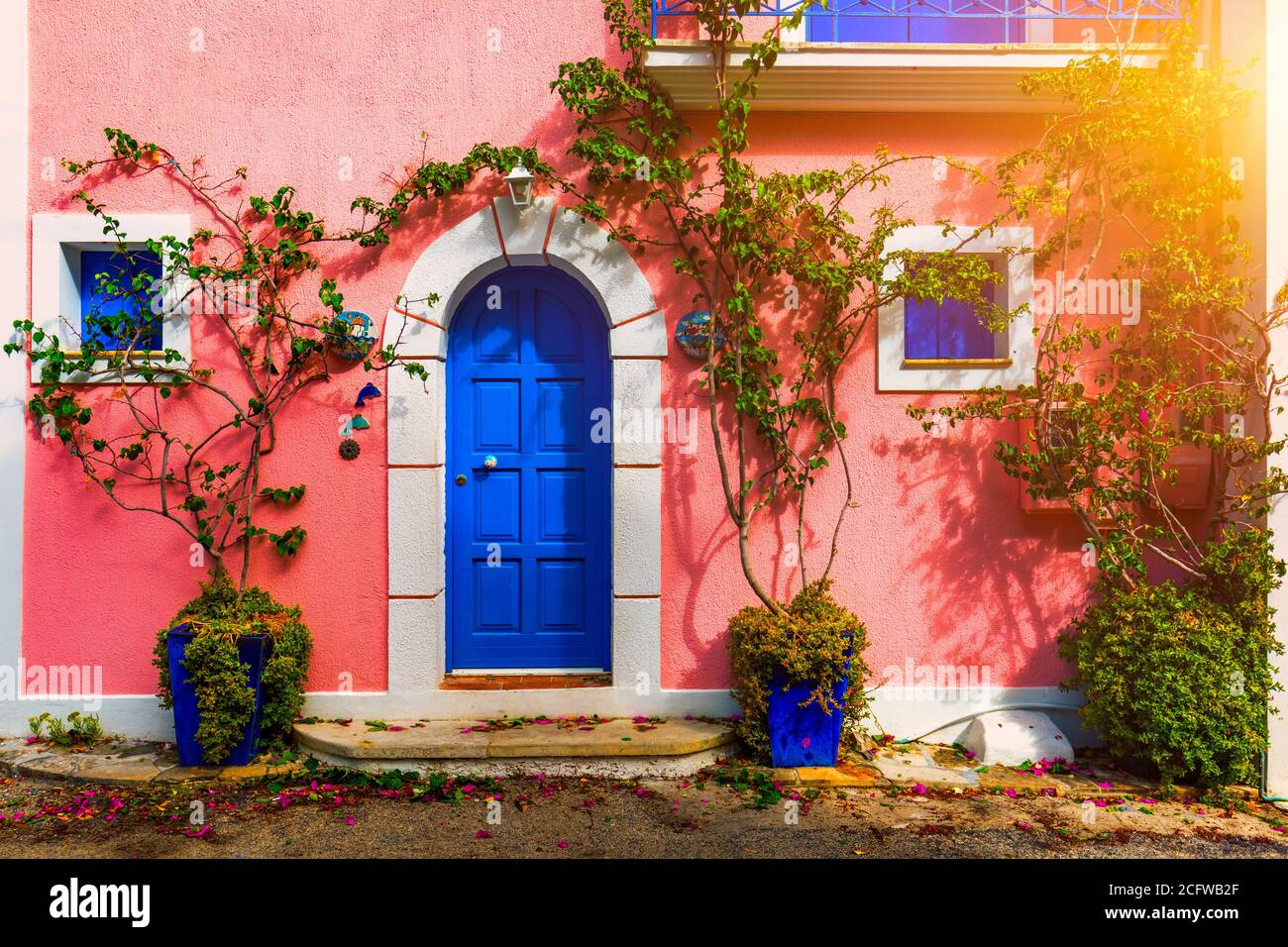 Traditional street with greek houses with flowers in Assos, Kefalonia ...