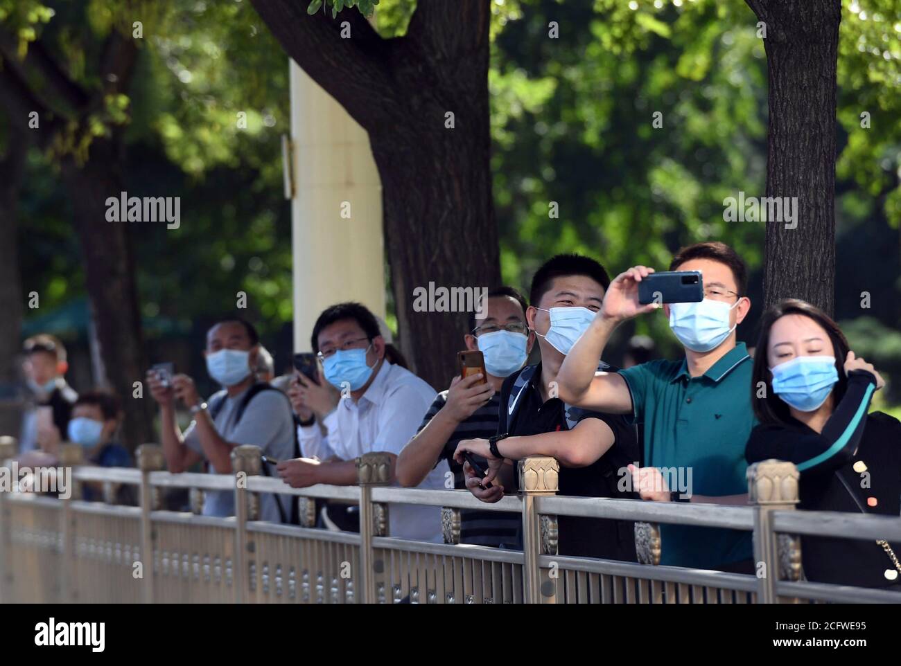 Beijing, China. 8th Sep, 2020. People watch as the motorcade carrying ...