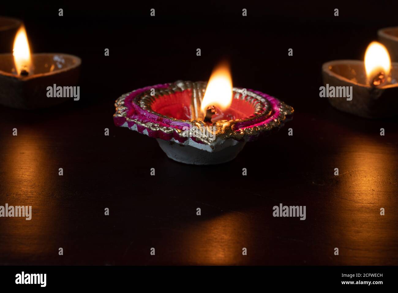 Decorative colourful diya lamps lit during diwali Stock Photo - Alamy