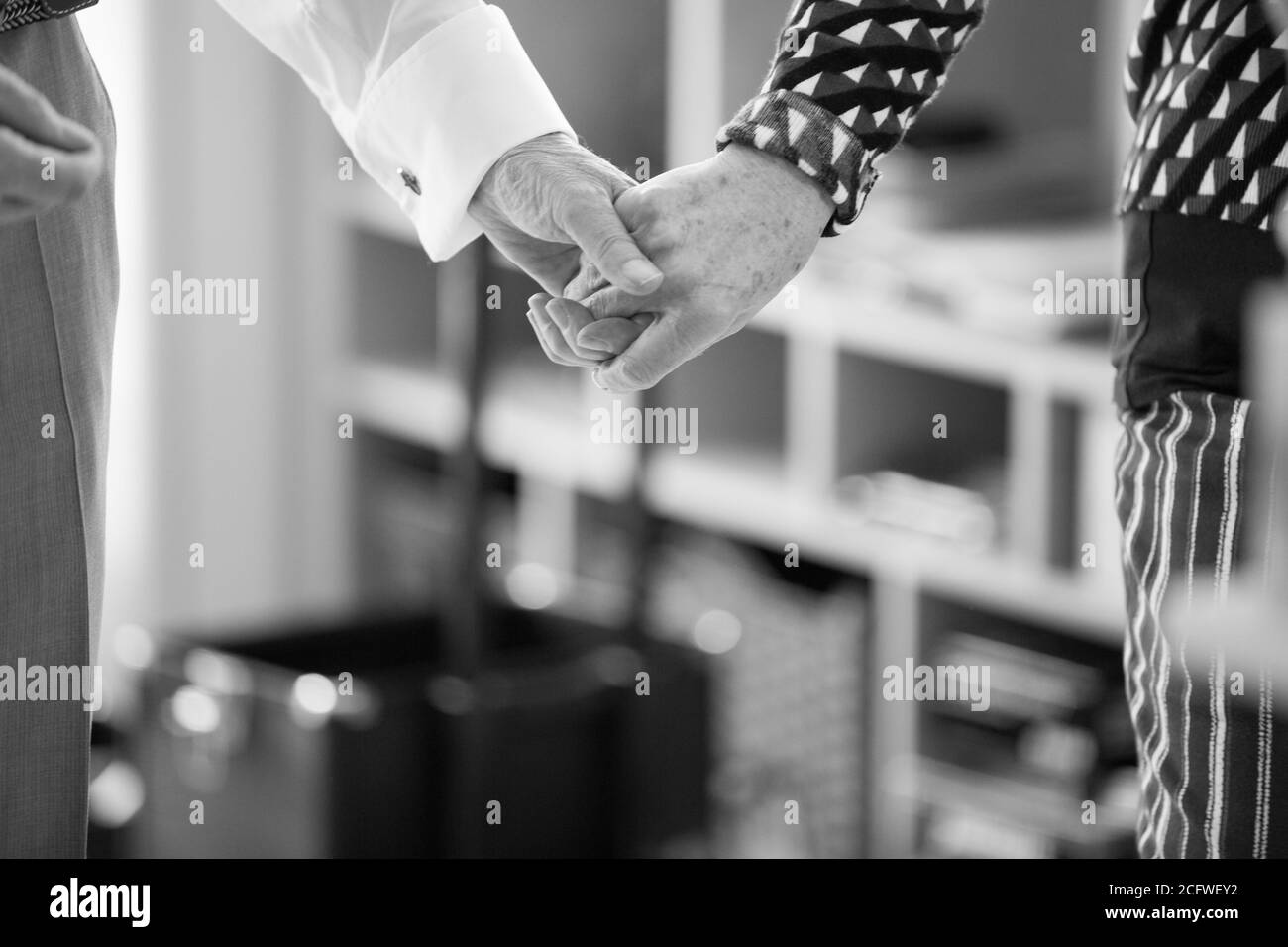 Elderly couple holding hands Stock Photo - Alamy
