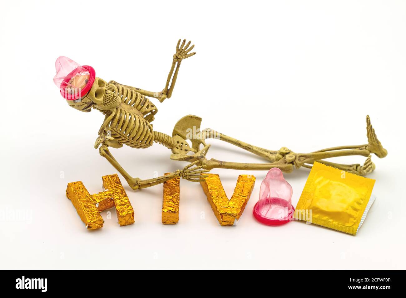 Still life concept human body bone wear condoms and A word HIV on white ...
