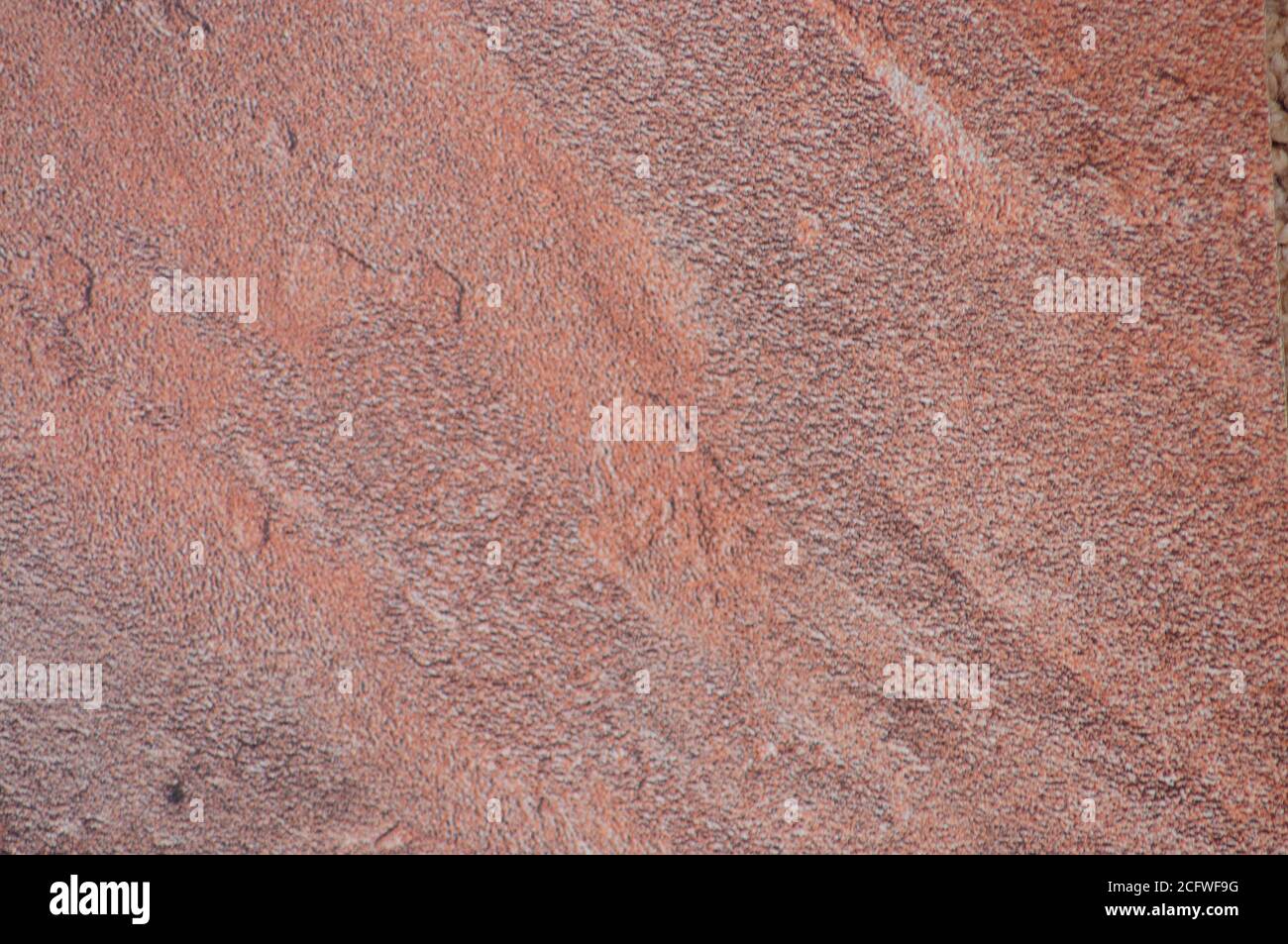 Close-up of the surface of a natural stone with traces of deep erosion ...