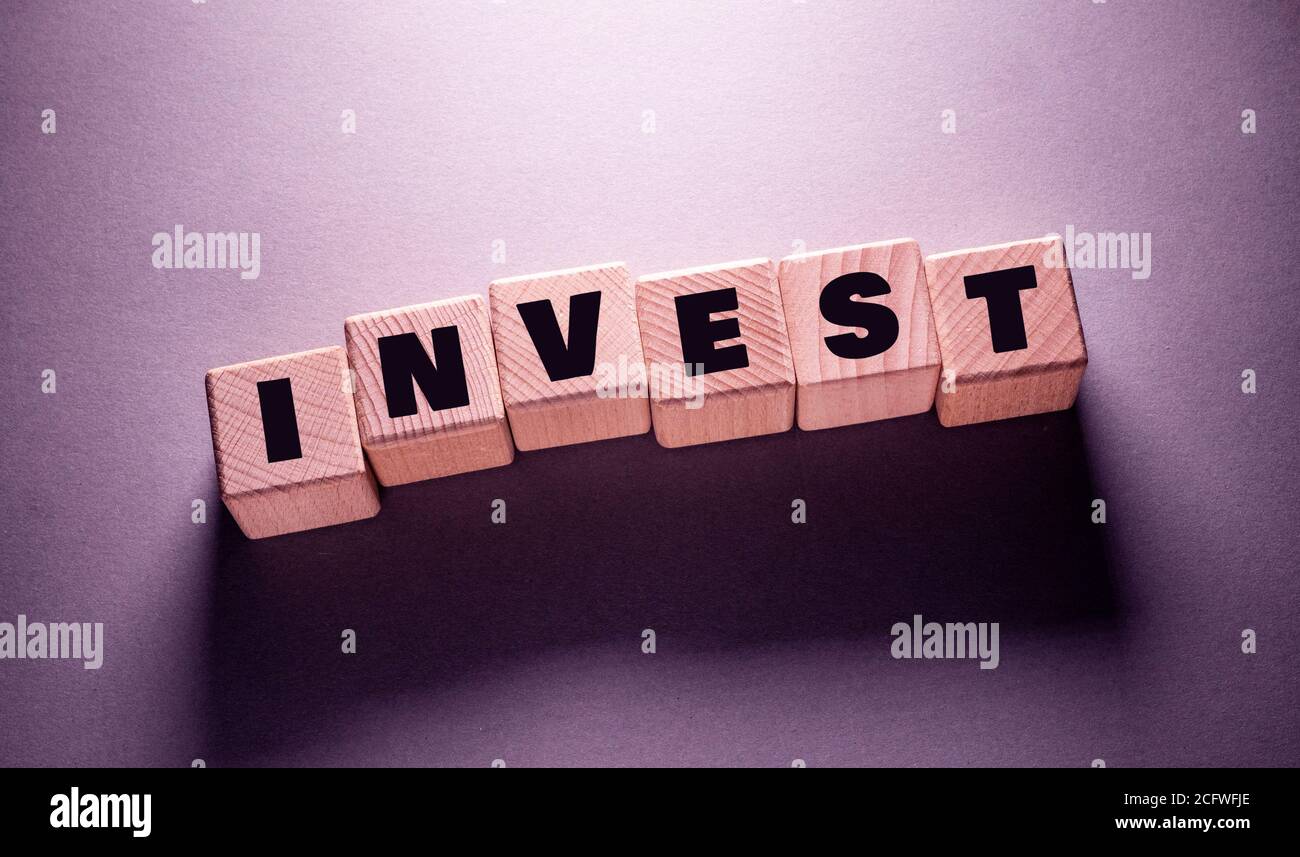 Invest Word Written on Wooden Cubes Stock Photo - Alamy