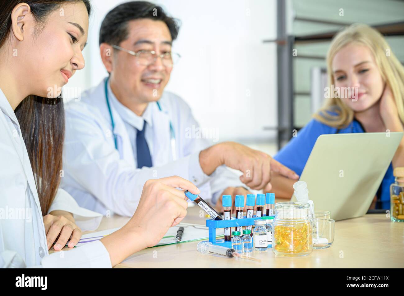 Group of doctors wearing formal white coat and blue scrubs suit ...