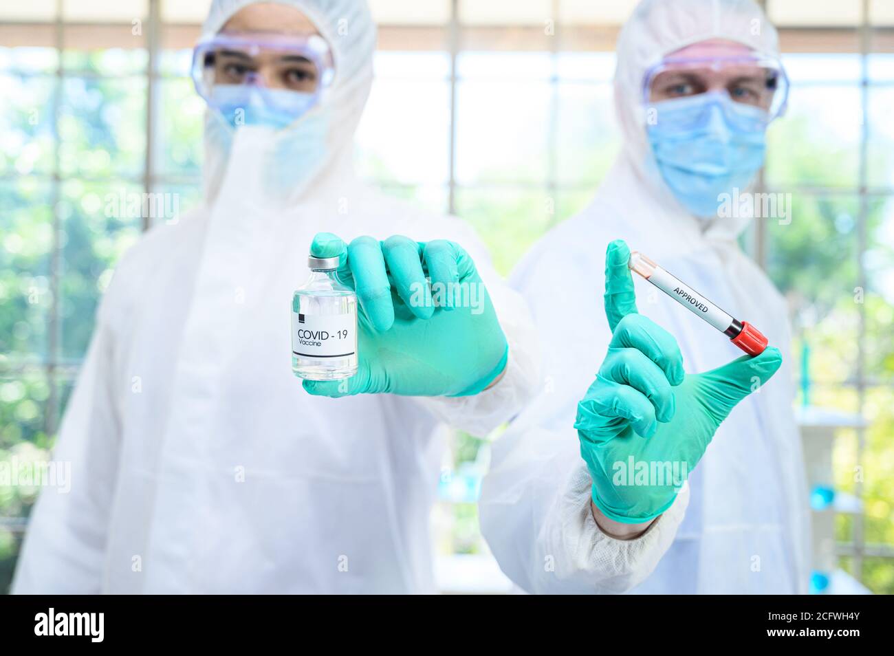 Couple male scientist wearing protection suit holding Coronavirus ...