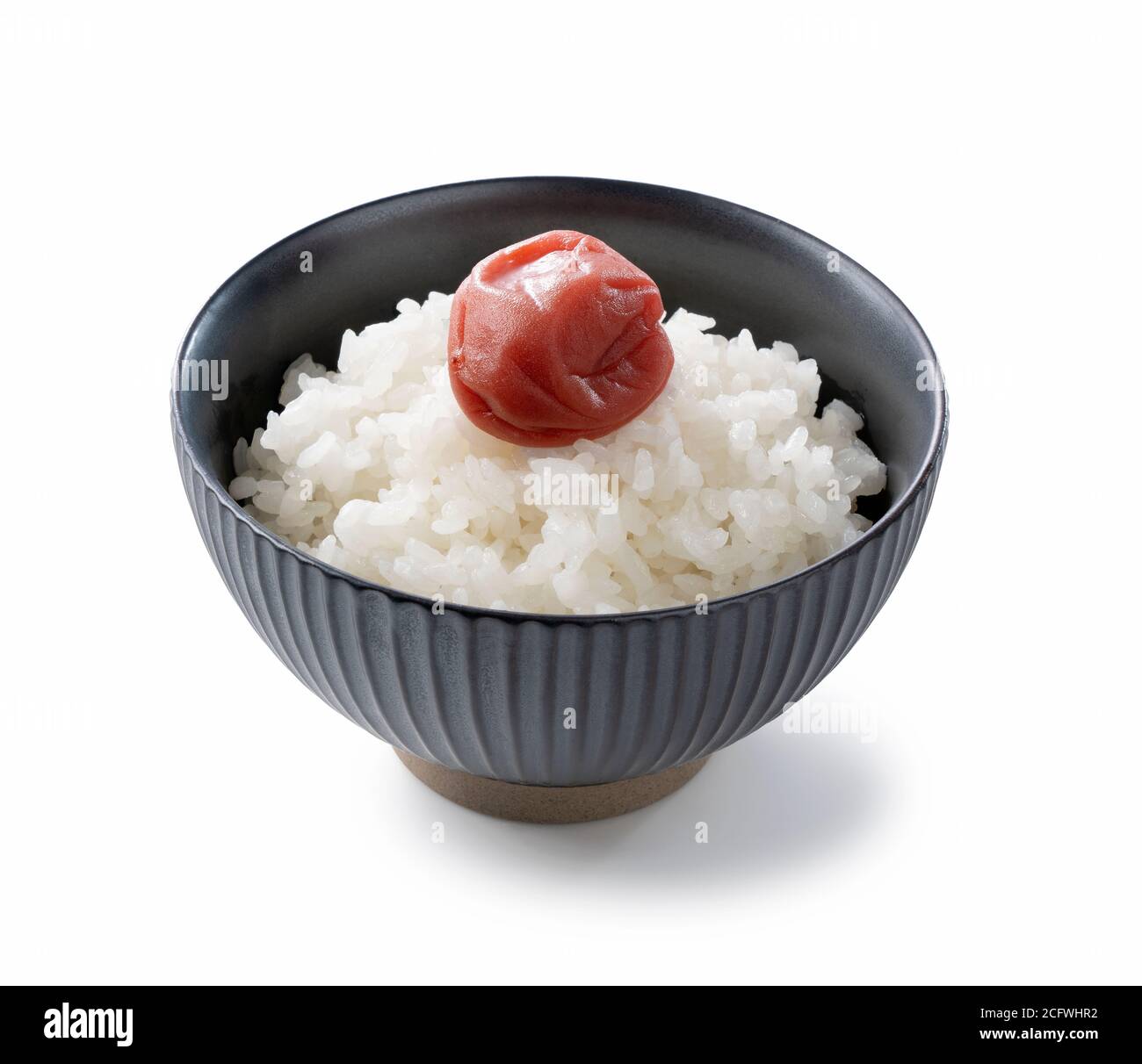 Japanese pickled plums and freshly cooked rice on a white background ...
