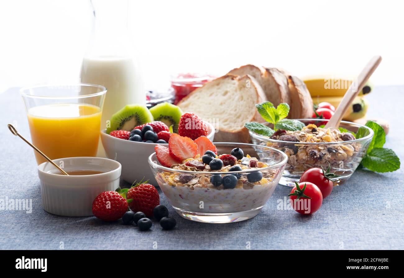 Images of a sumptuous breakfast of granola, bread, fruit and juice ...