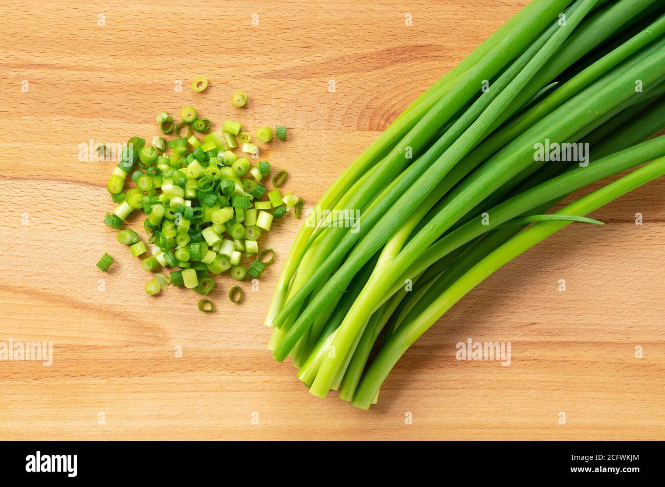 Chopped green onions placed on the cutting board were photographed from ...