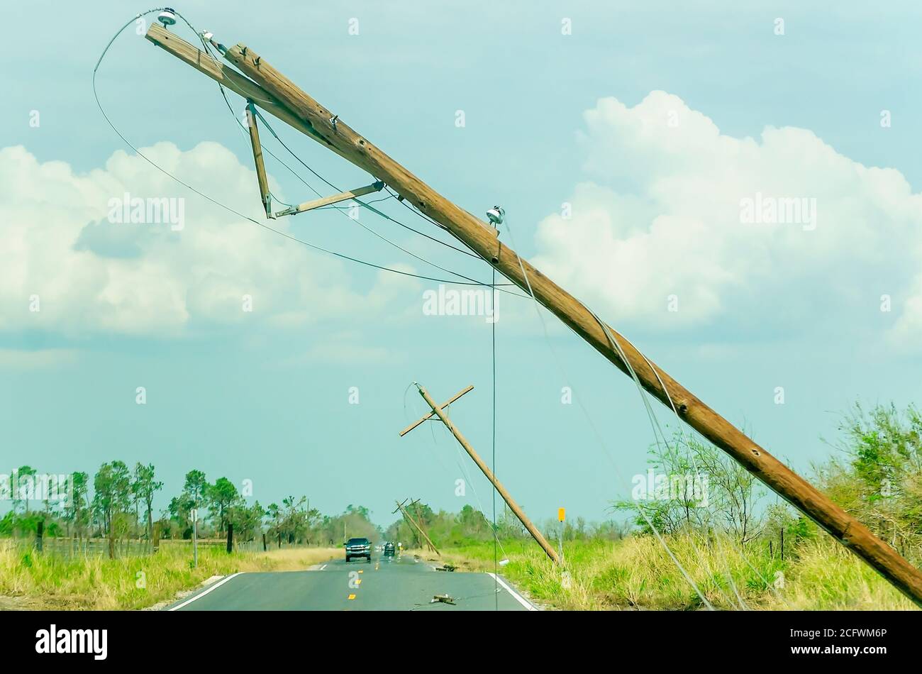Drivers pass damaged power lines on Ward Line Road after Hurricane ...