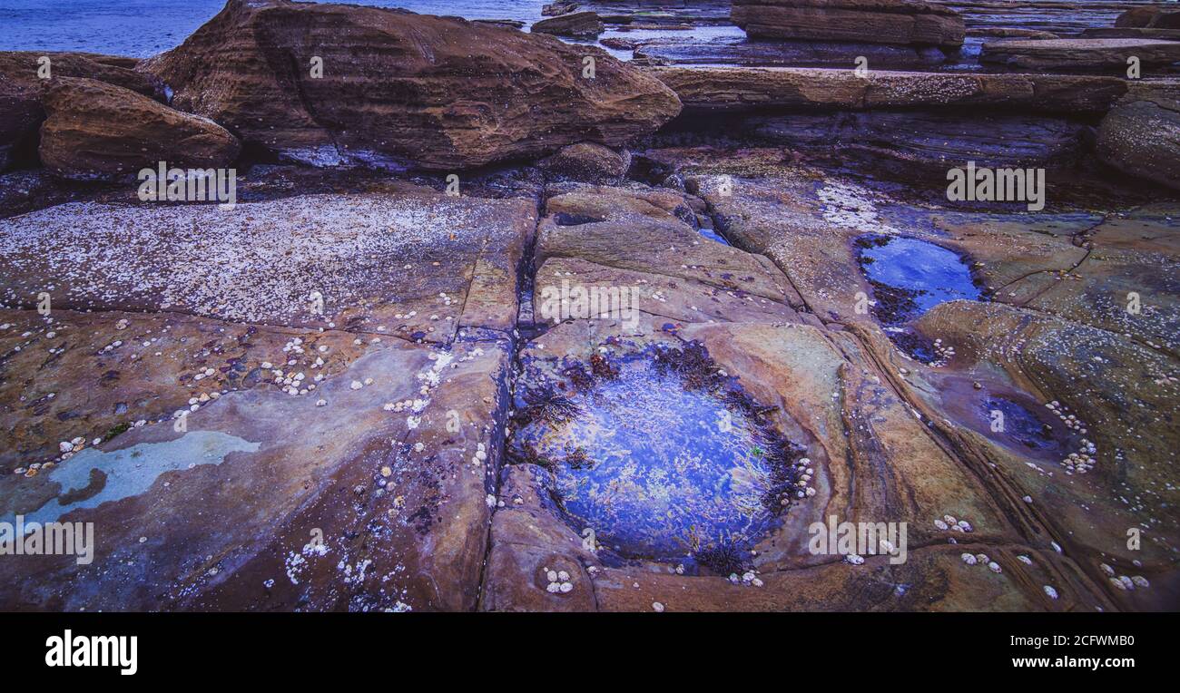 Bed of Rocks and Holes with Water Stock Photo - Alamy