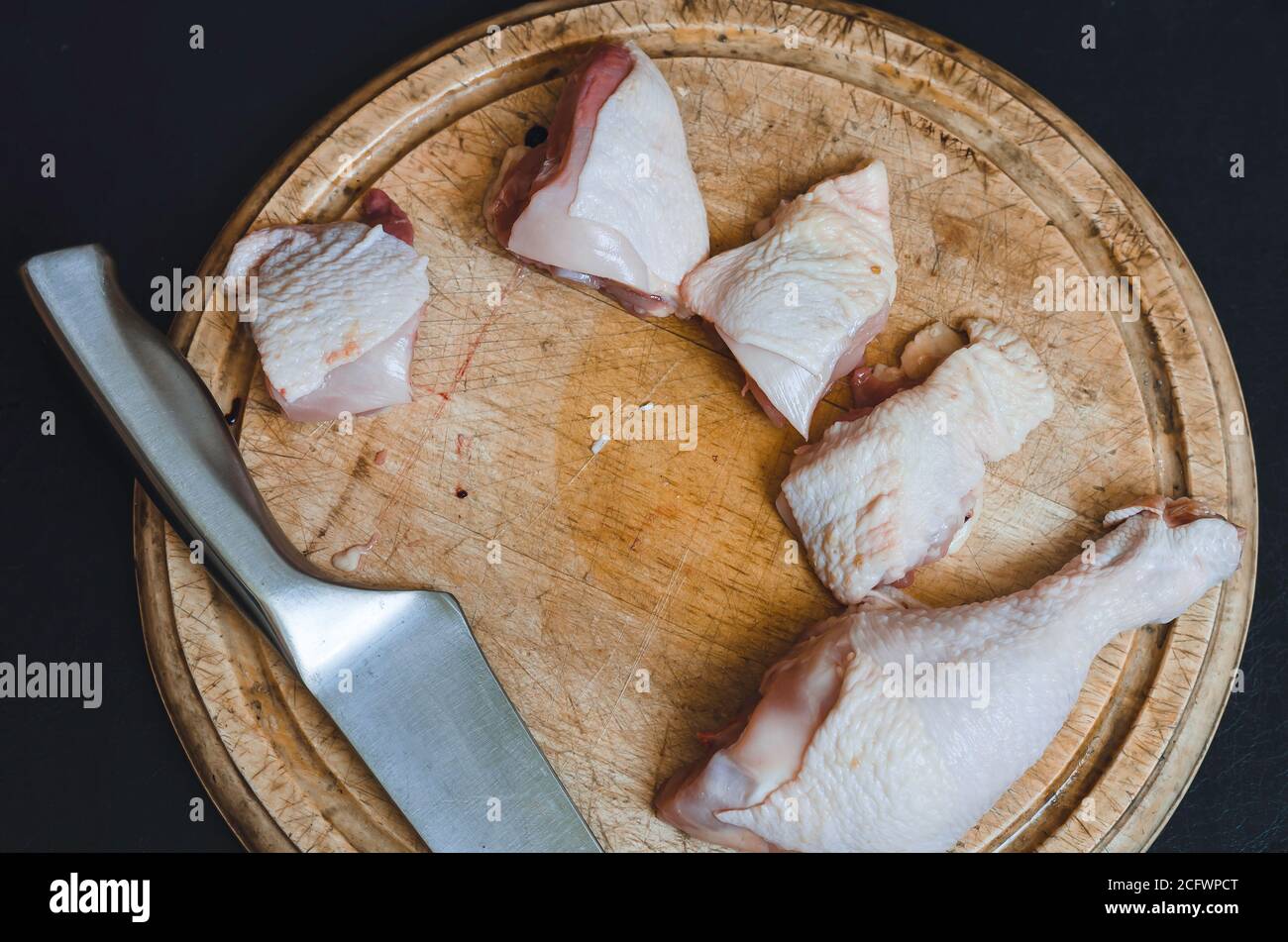 Raw chicken meat and kitchen knives on the chopping board. Chicken ...