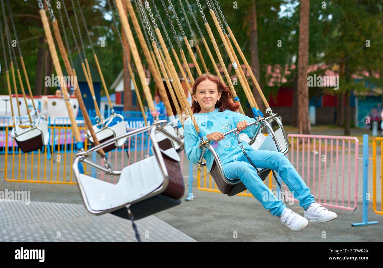 funny girl rides on a carousel Stock Photo - Alamy