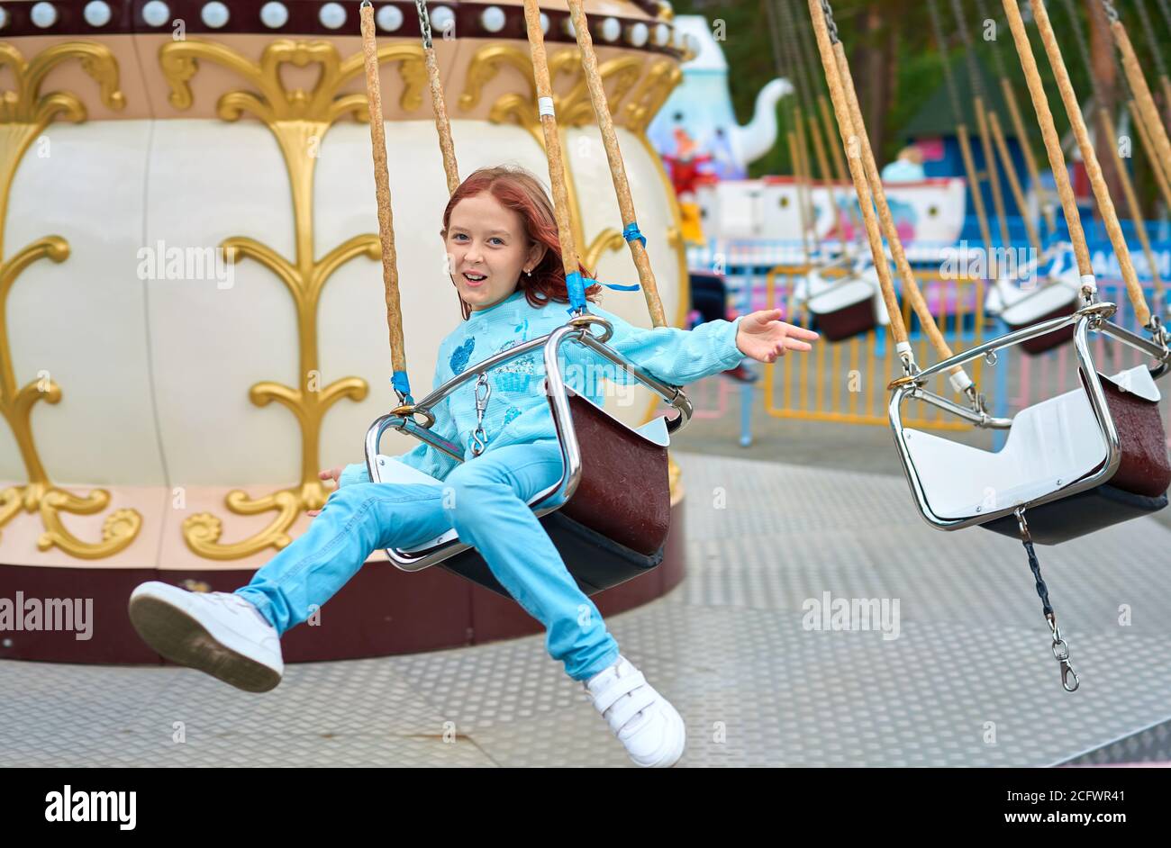 funny girl rides on a carousel Stock Photo - Alamy