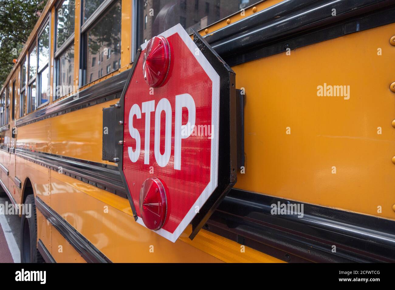 A red stop sign with lights on the side of a yellow school bus Stock ...