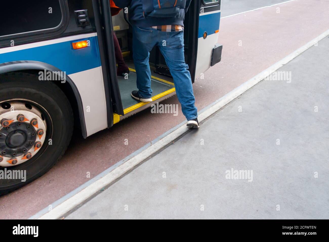 stepping into a city transit bus Stock Photo - Alamy