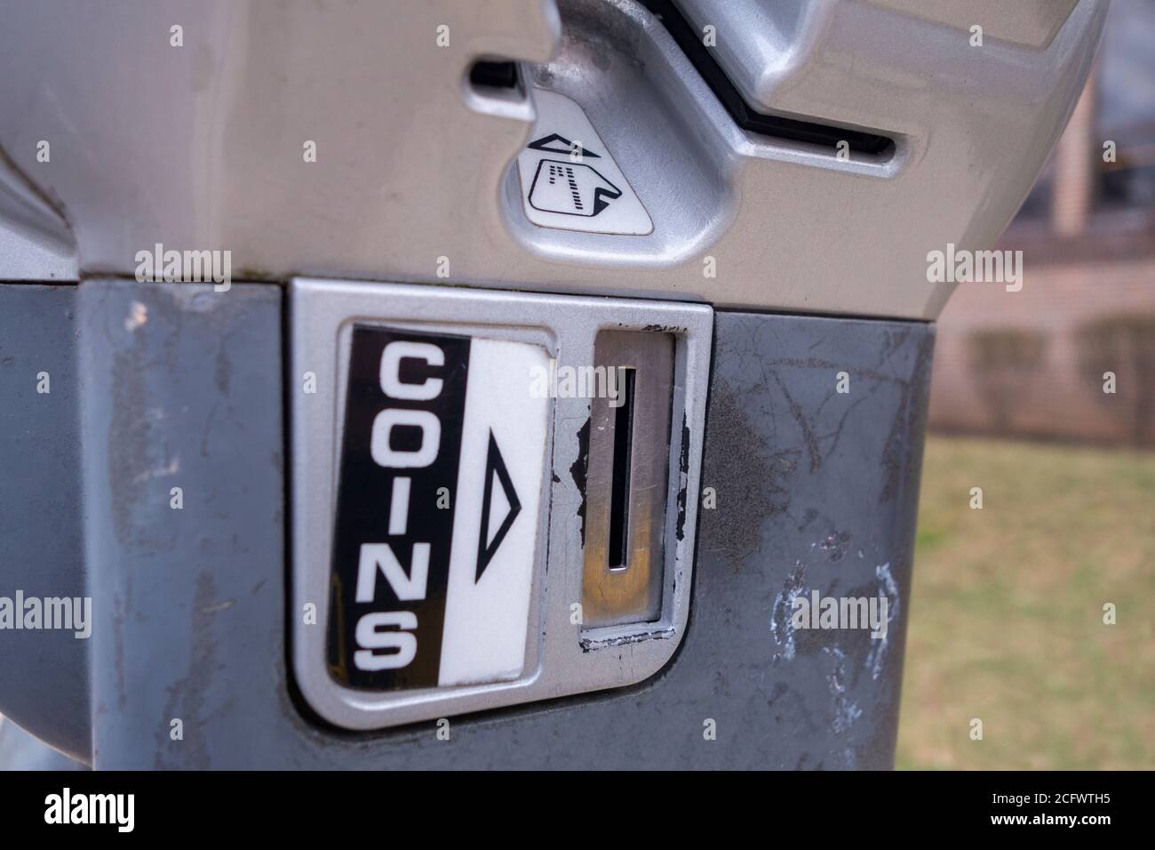 coins for parking time in a parking meter metal coon slot Stock Photo ...