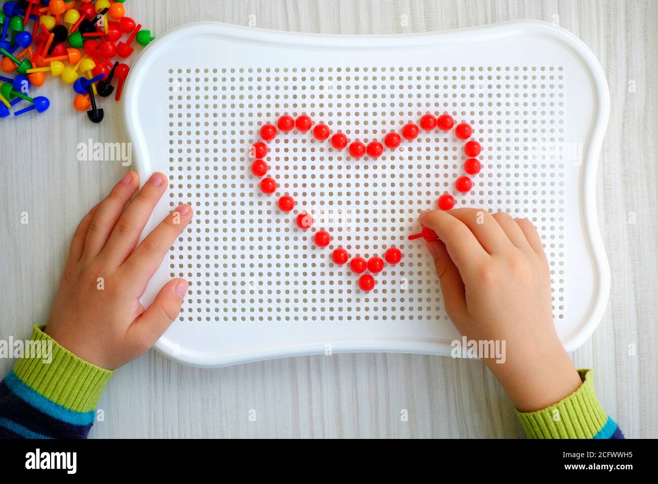 The child playing with a mosaic Stock Photo - Alamy