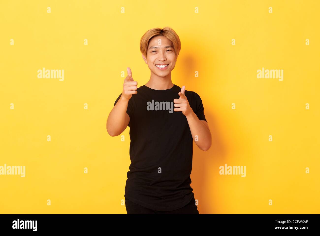 Portrait of cheeky smiling asian guy, looking satisfied and pointing ...