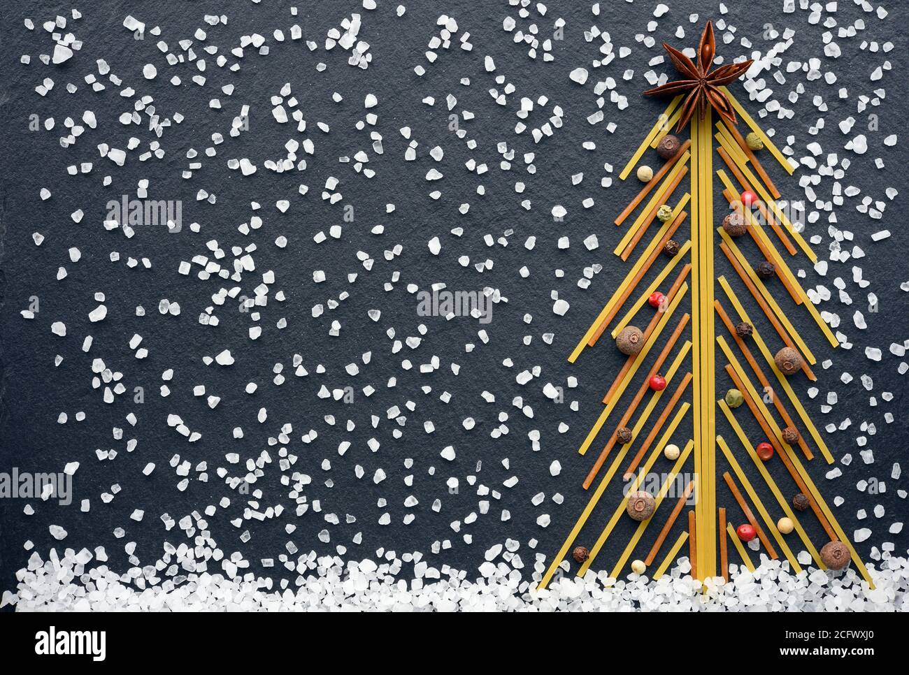 Christmas tree made of italian spaghetti, salt and colorful pepper on a ...