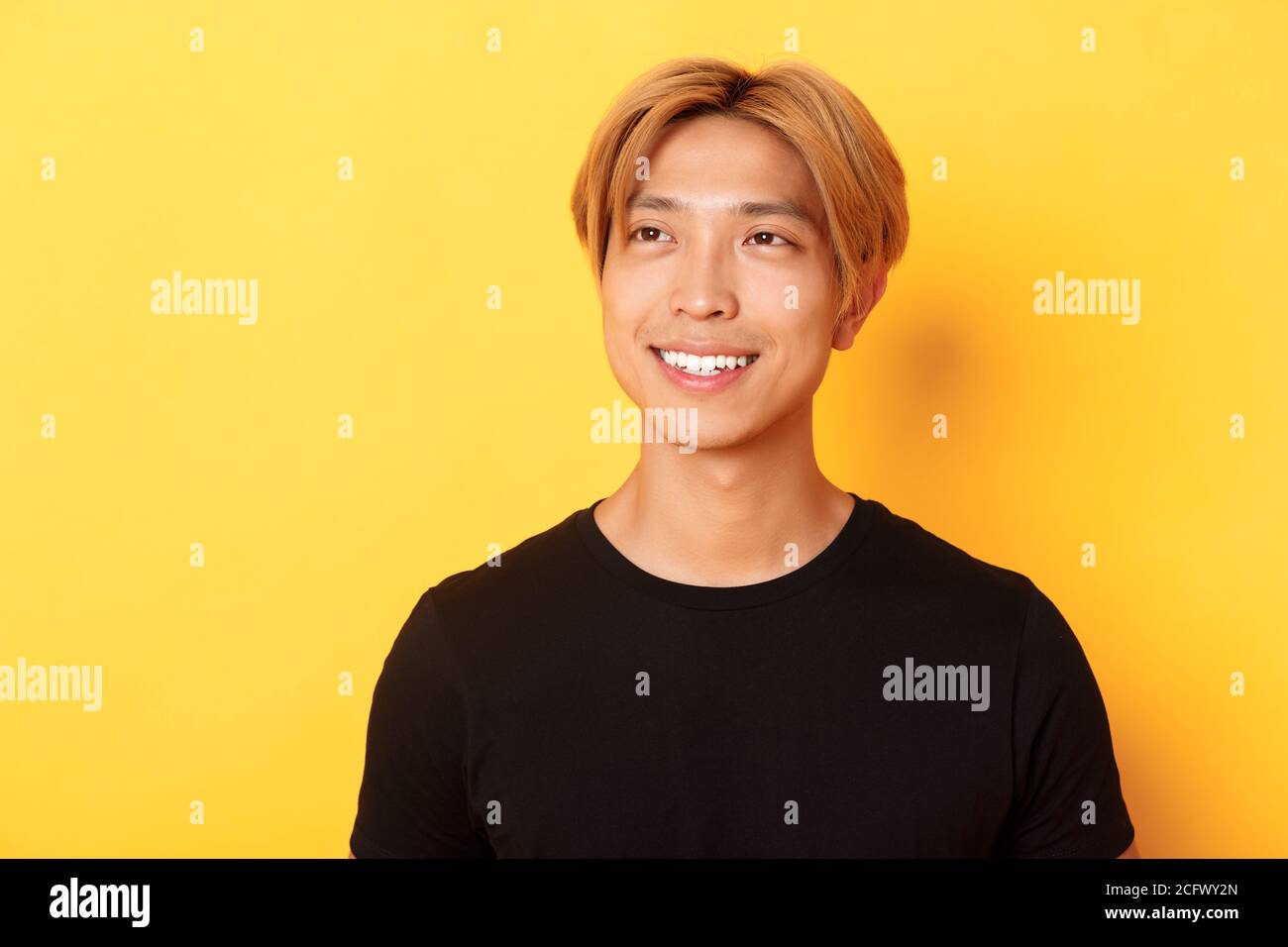 Close-up of handsome stylish korean guy with fair hair, looking dreamy ...