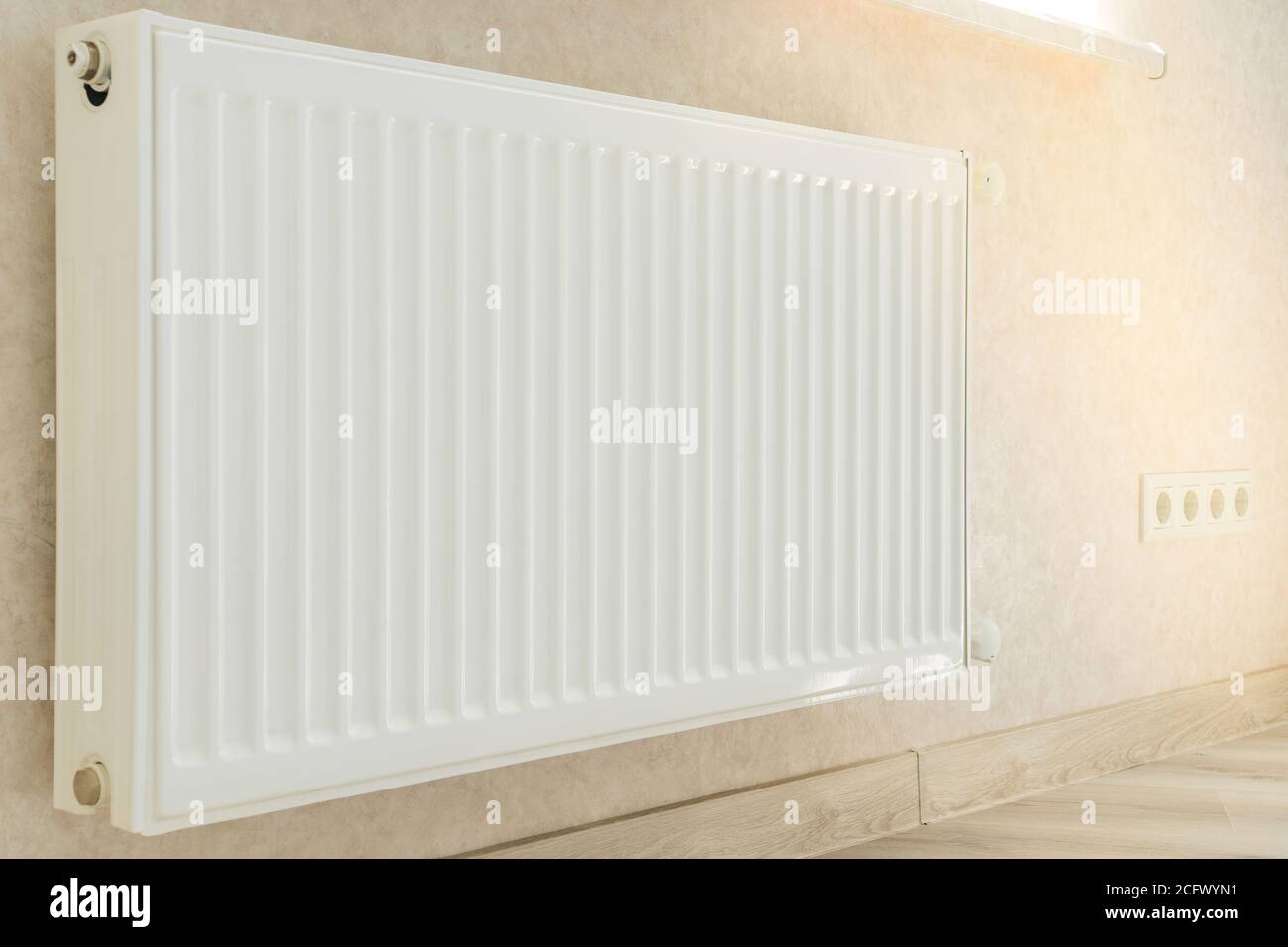 Individual heating radiator on a wall at an apartment Stock Photo - Alamy