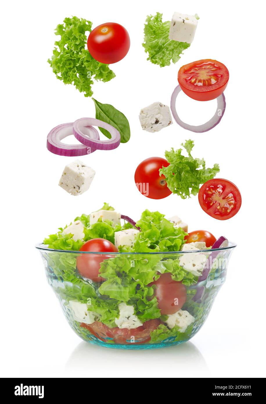 Falling vegetables in a salad bowl, white background Stock Photo - Alamy