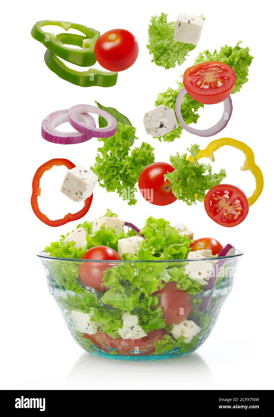 Falling vegetables in a salad bowl, white background Stock Photo - Alamy