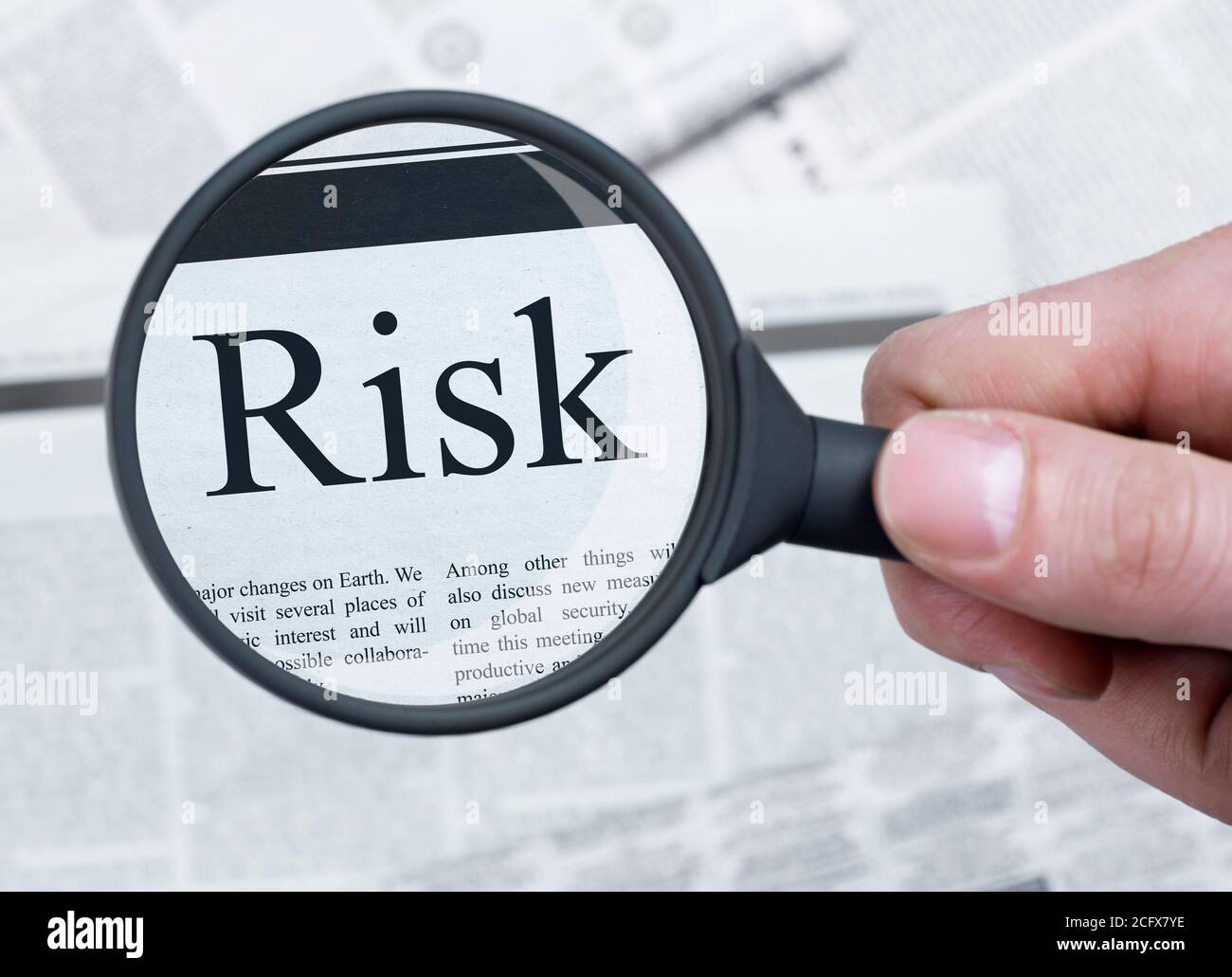 Risk under magnifying glass Stock Photo - Alamy