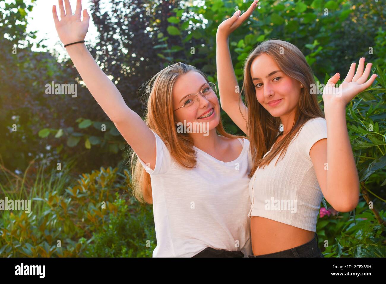 Two friends making funny gestures in nature Stock Photo - Alamy