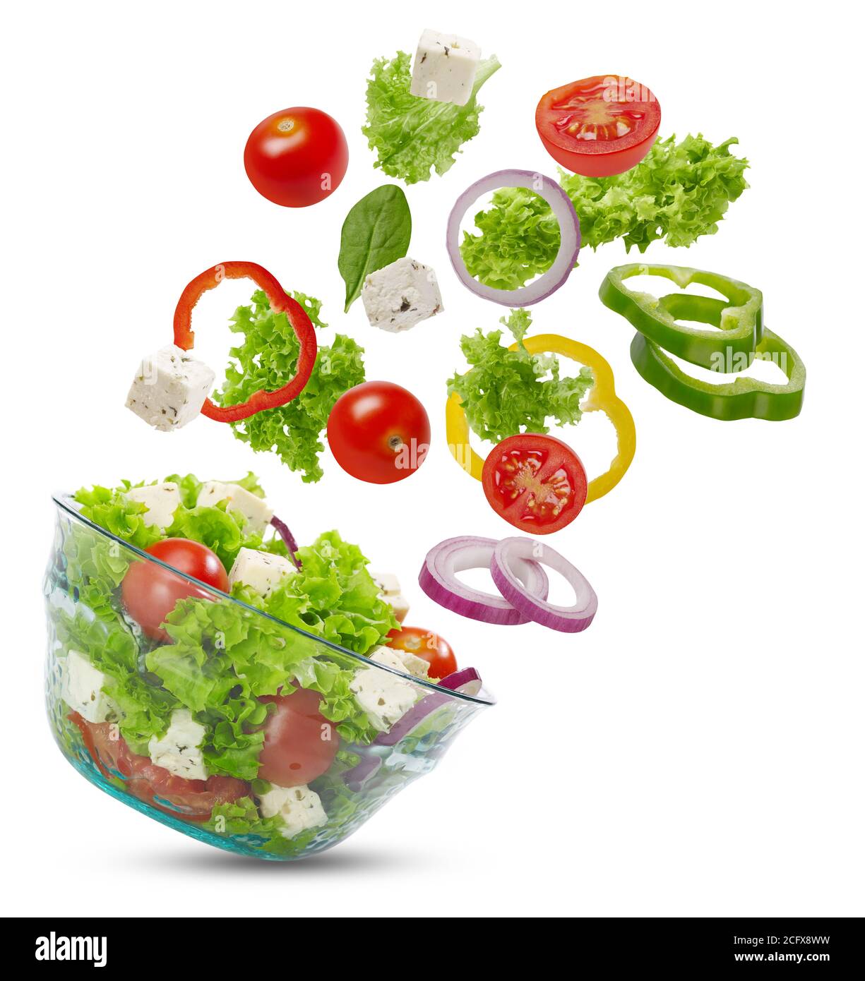 Falling vegetables in a salad bowl, white background Stock Photo - Alamy