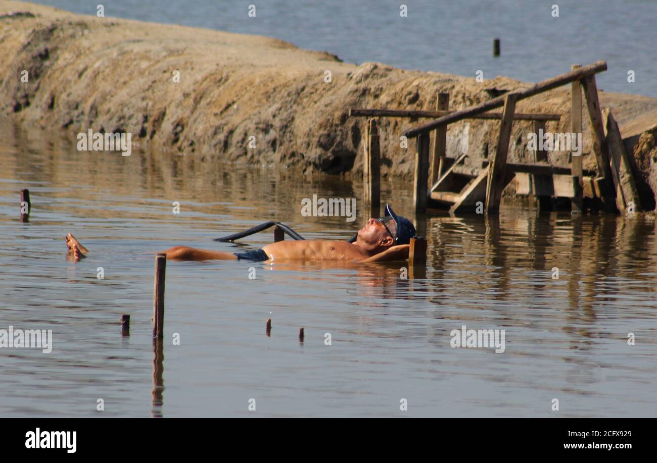 Visitors enjoy the mud-bathing process to help people who suffer from ...