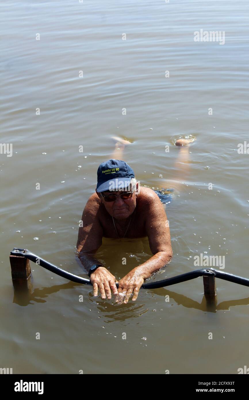 Visitors enjoy the mud-bathing process to help people who suffer from ...