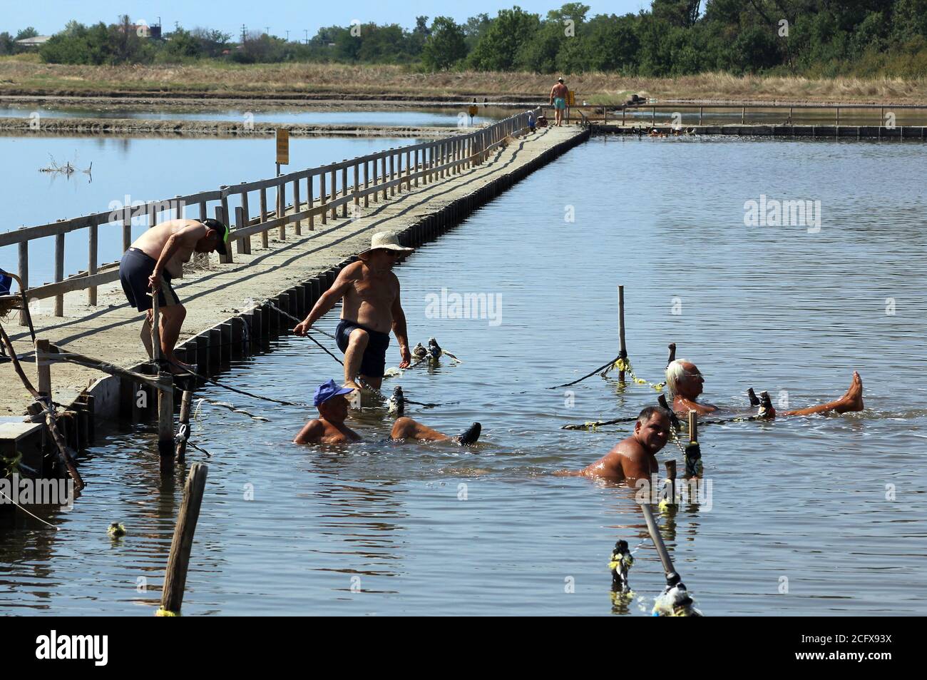Visitors enjoy the mud-bathing process to help people who suffer from ...