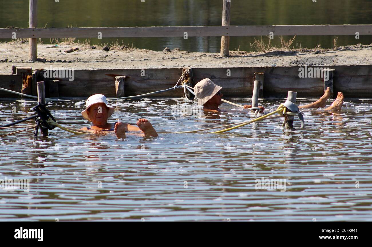 Visitors enjoy the mud-bathing process to help people who suffer from ...