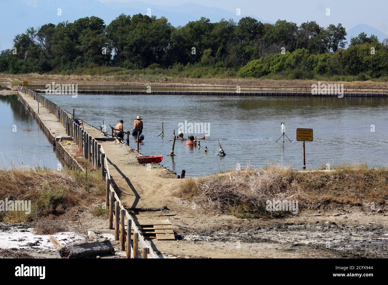 Visitors enjoy the mud-bathing process to help people who suffer from ...