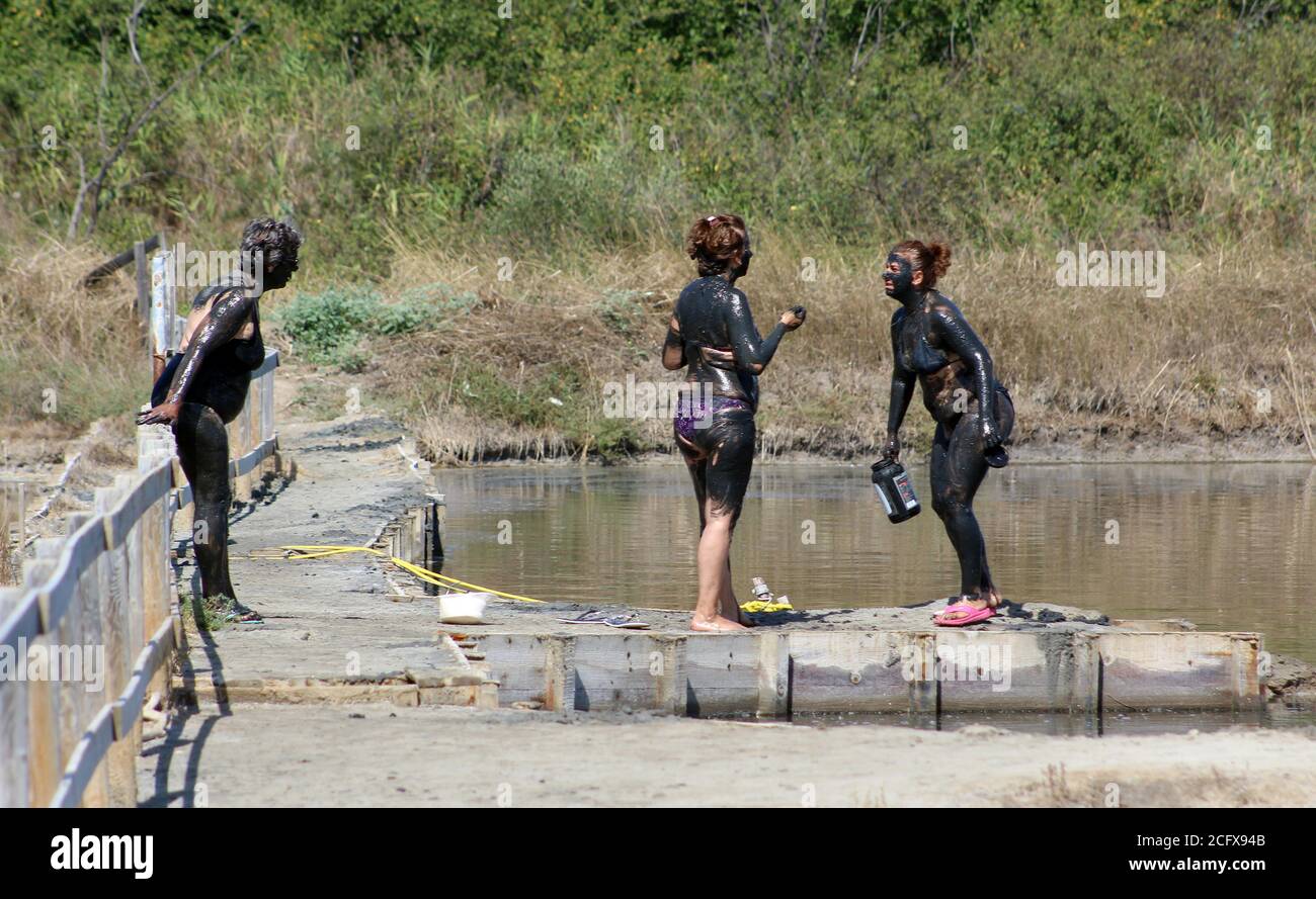 Visitors enjoy the mud-bathing process to help people who suffer from ...