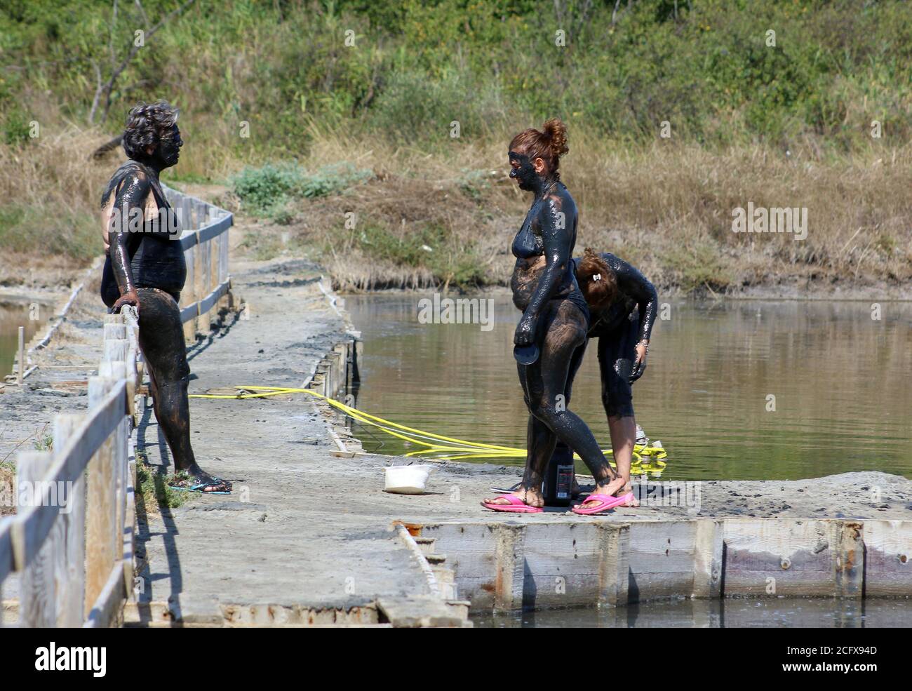 Visitors enjoy the mud-bathing process to help people who suffer from ...