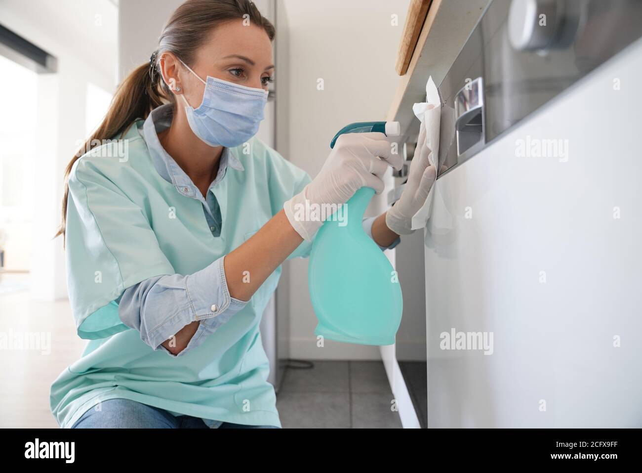 Cleaning woman working with protection mask and gloves Stock Photo - Alamy