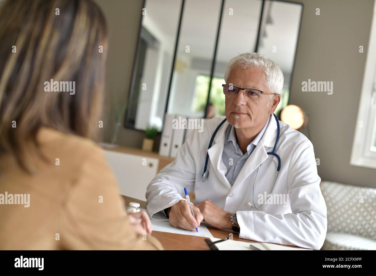 Doctor attending patient hi-res stock photography and images - Alamy