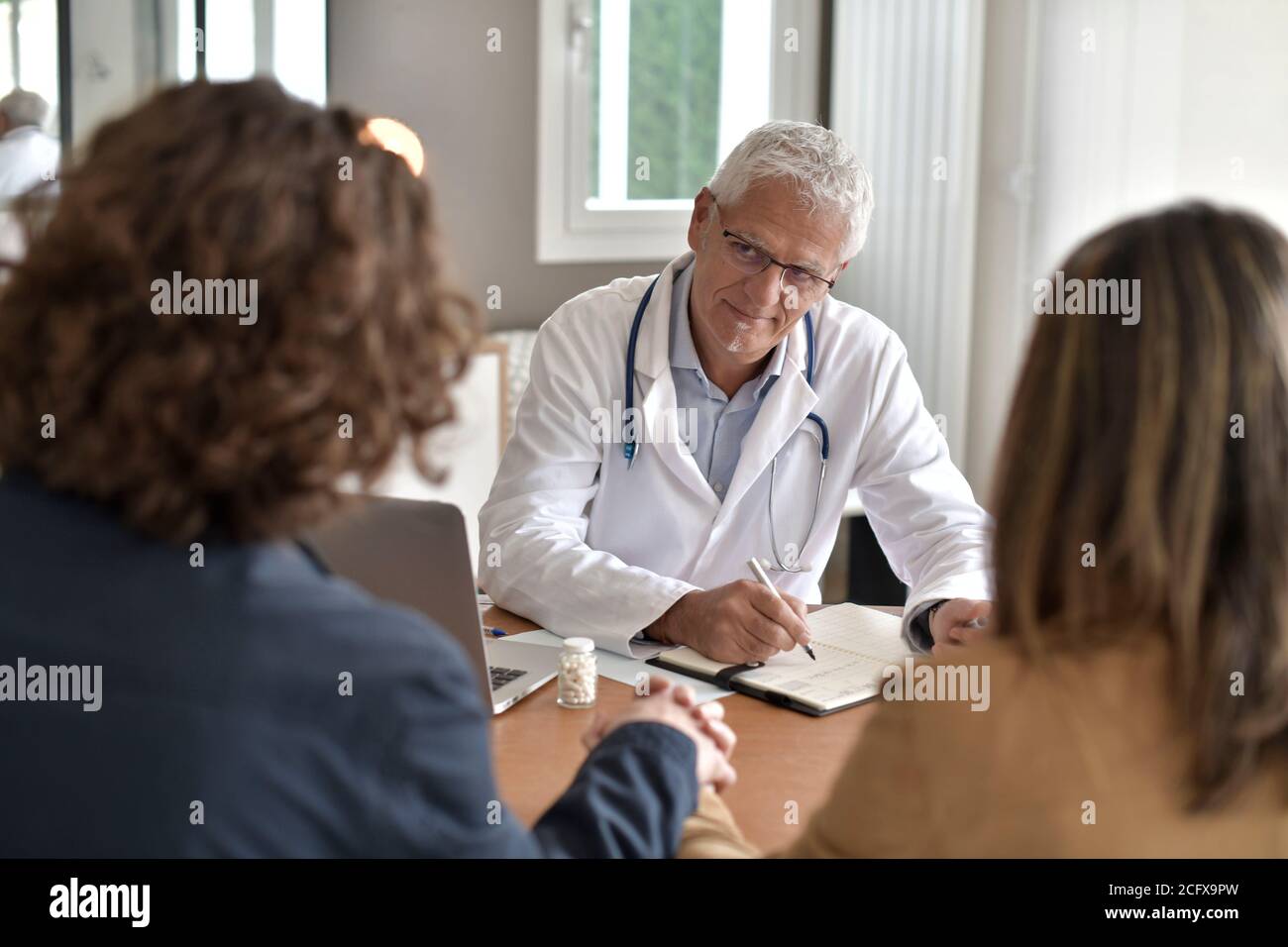 Young couple having an appointment at the doctor's office Stock Photo ...