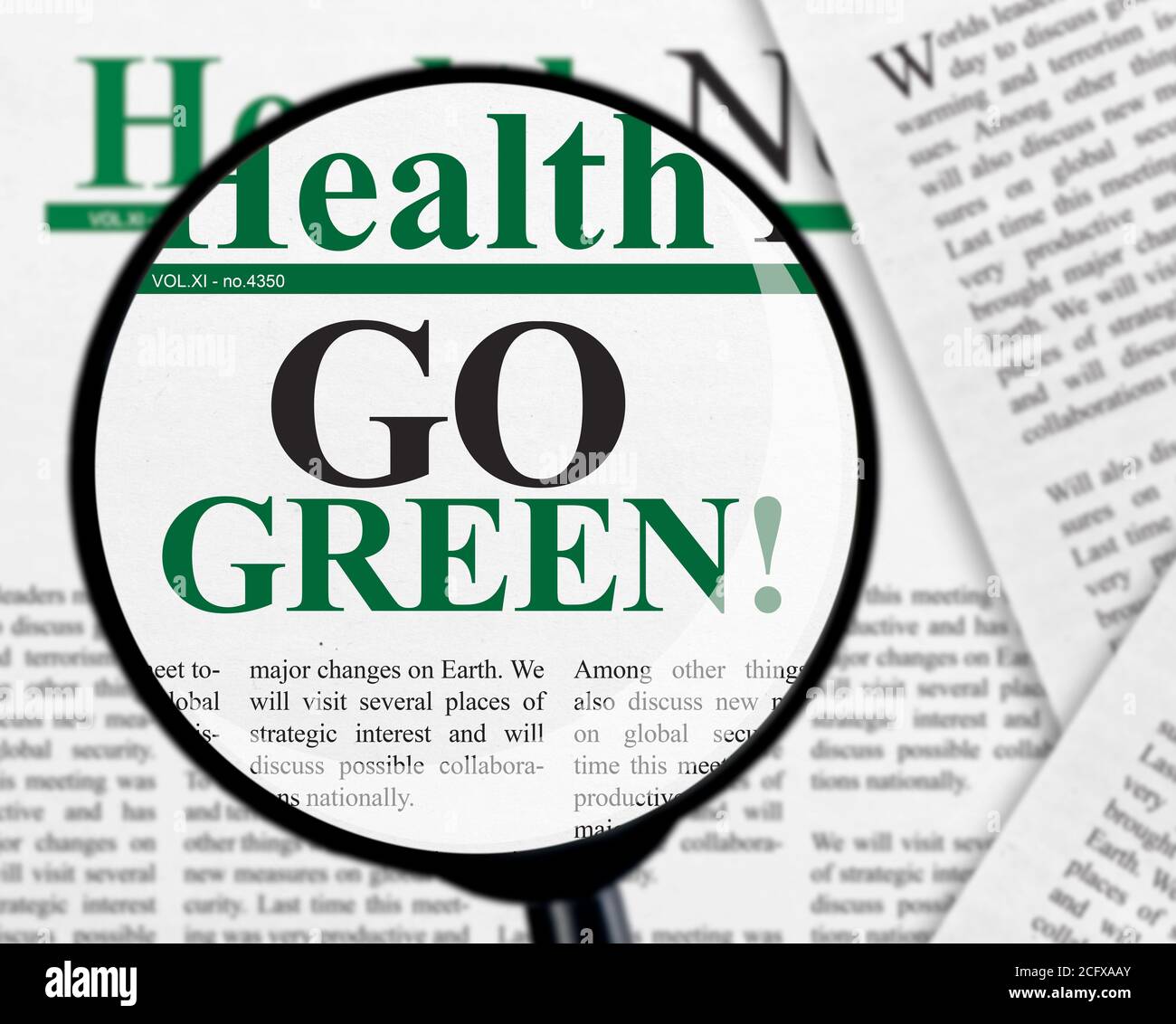 Go green headline under magnifying glass Stock Photo - Alamy