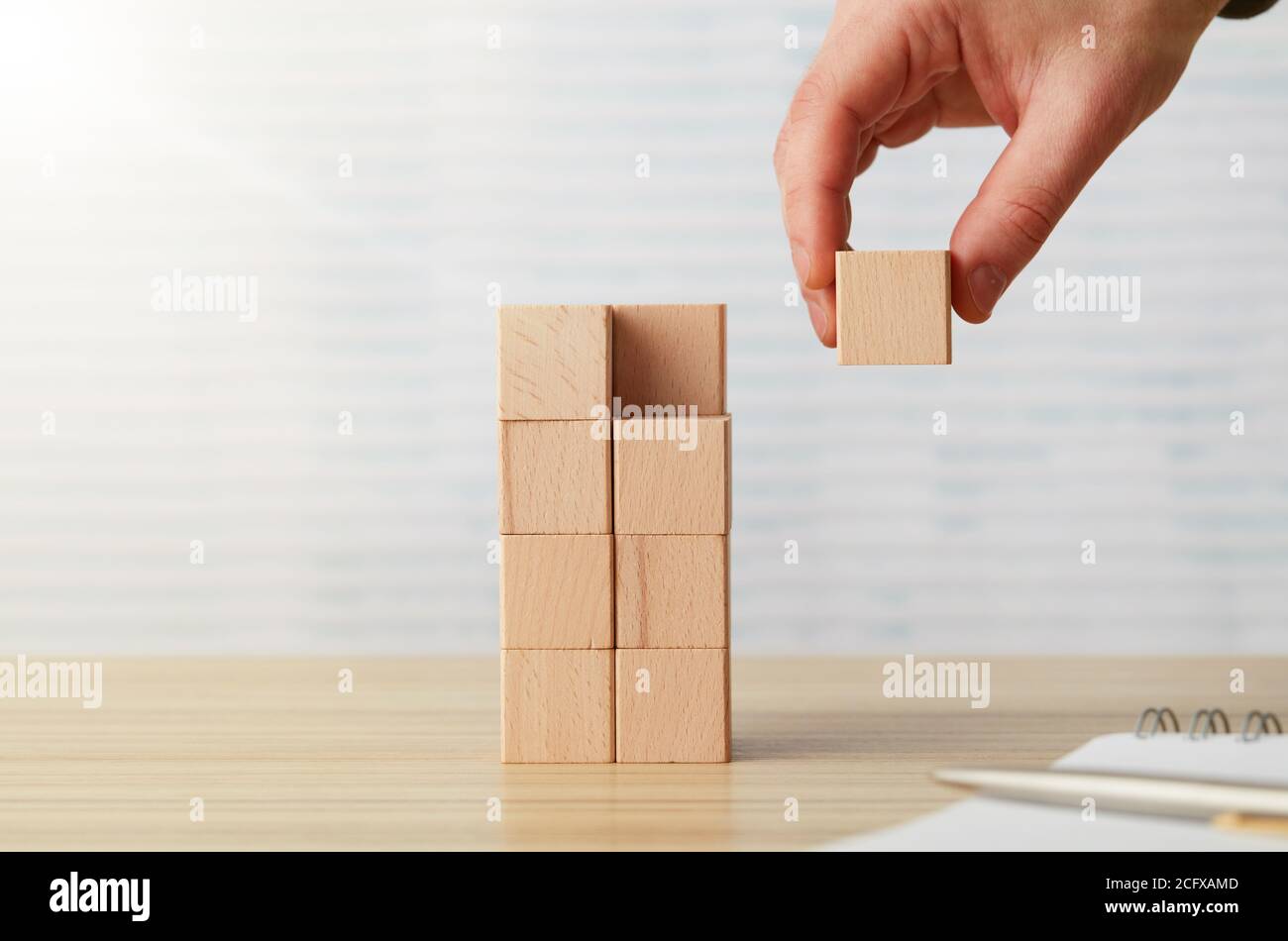 Hand arranging wooden cubes hi-res stock photography and images - Alamy