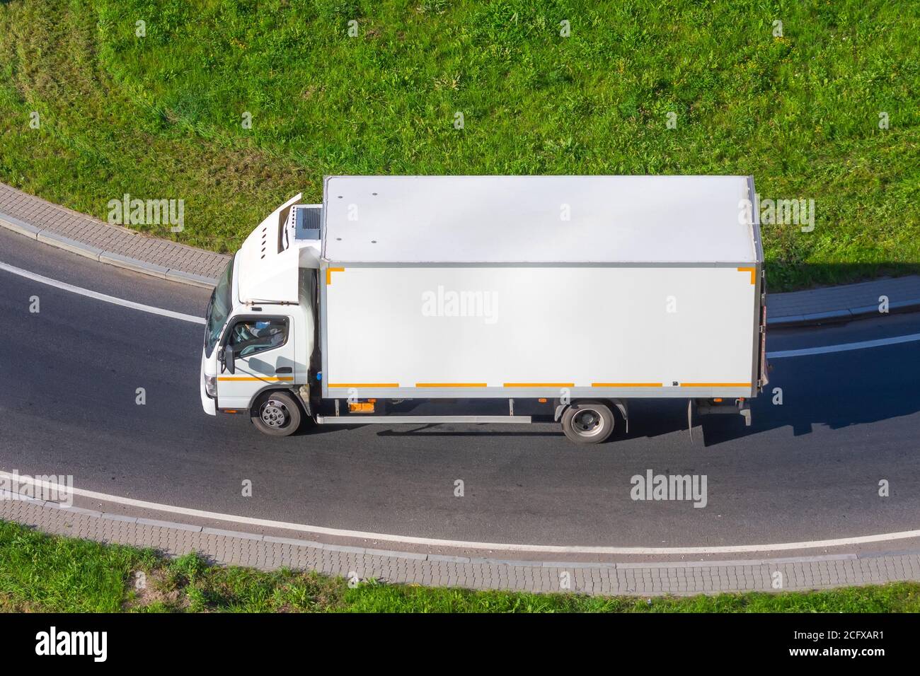 Small white truck on the highway turn Stock Photo - Alamy