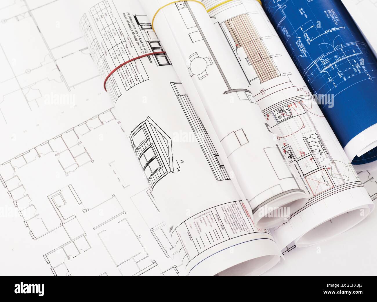 Rolled-up blueprints and house plans with copyspace Stock Photo - Alamy
