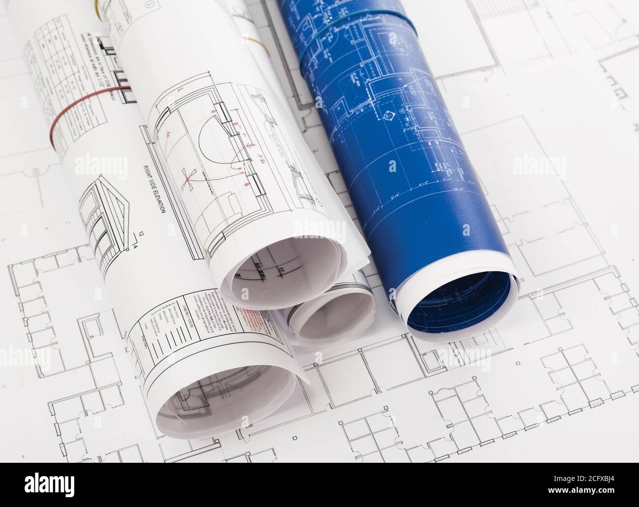 Rolled-up blueprints and house plans with copyspace Stock Photo - Alamy