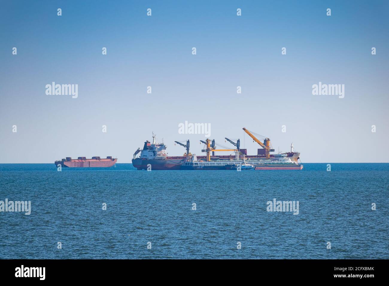 Bulk carrier is being loaded at sea Stock Photo - Alamy