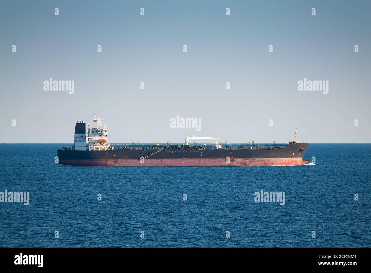 Oil tanker is moving along the calm sea Stock Photo - Alamy